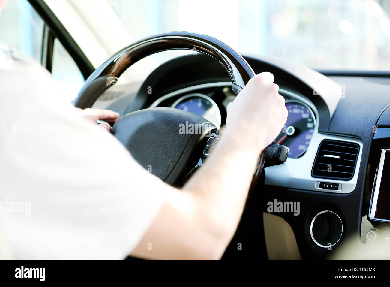 Man's hands on a steering wheel Stock Photo - Alamy