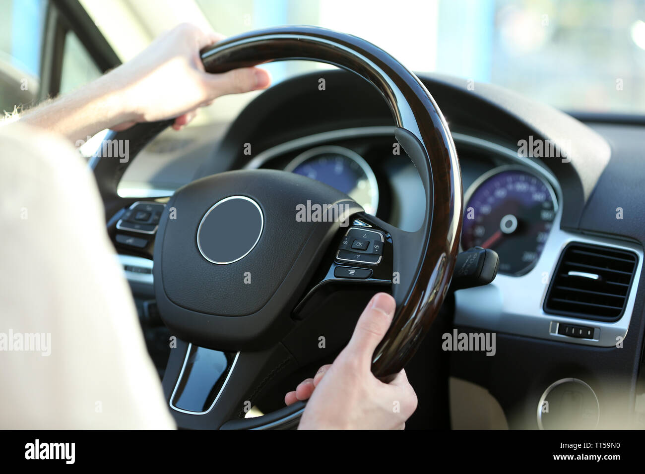 Man's hands on a steering wheel Stock Photo - Alamy