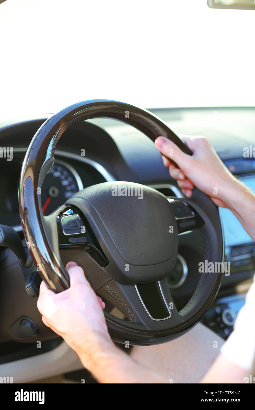 Man's hands on a steering wheel Stock Photo - Alamy