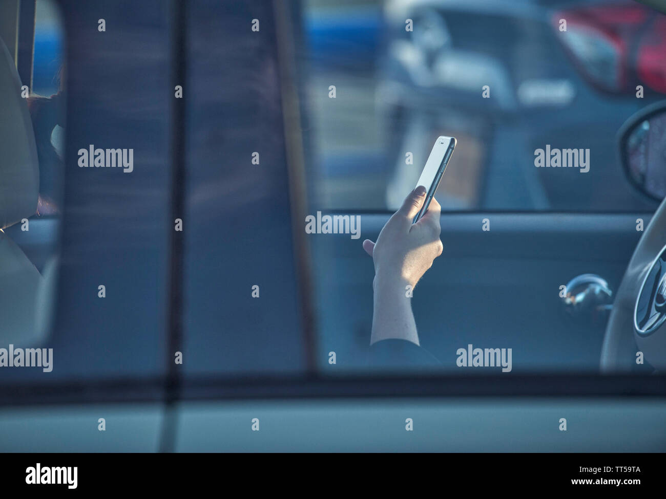 UNITED STATES - August 15, 2016: A commuter checks messages on her ...