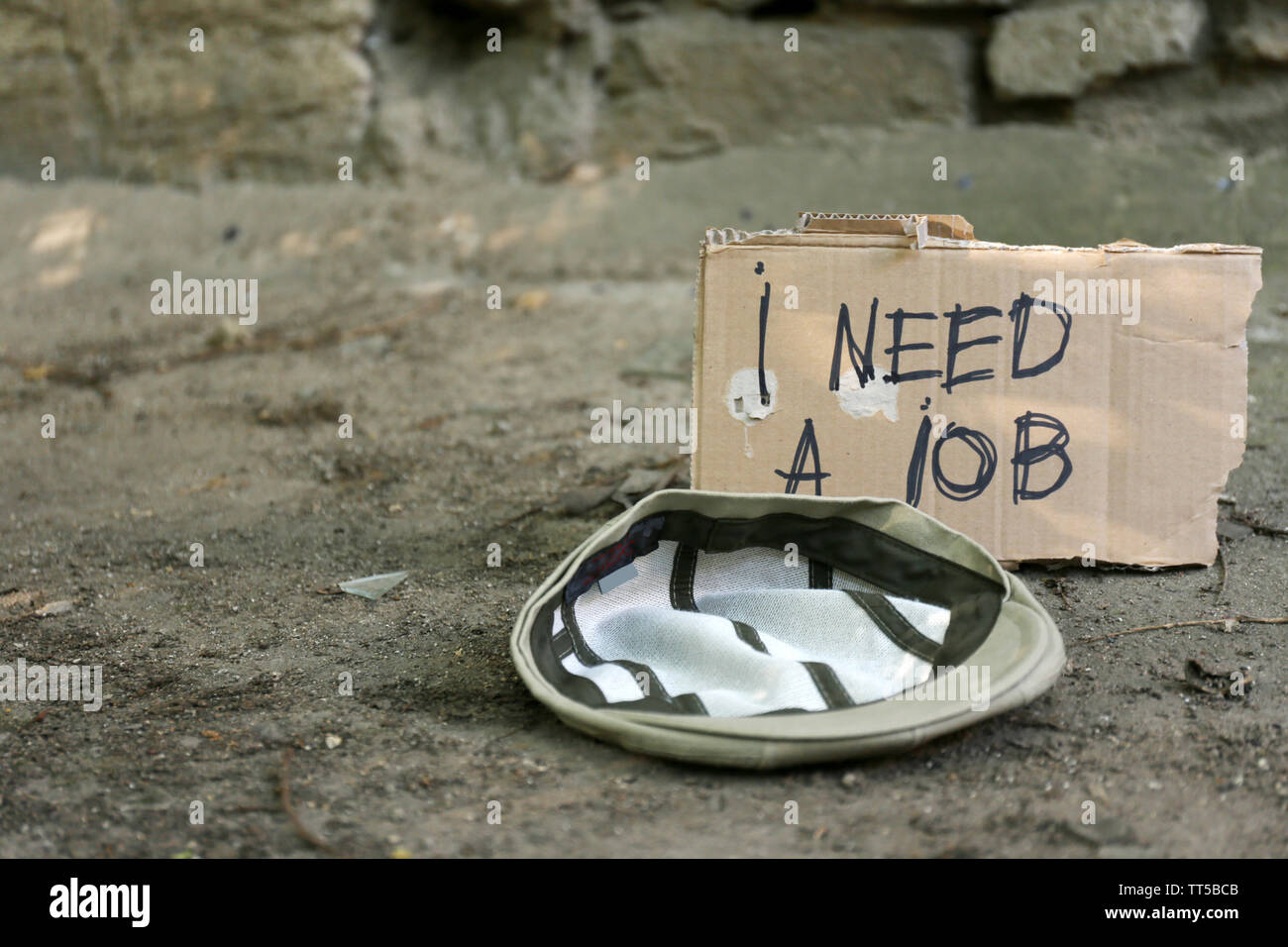 Hat homeless outdoors Stock Photo - Alamy