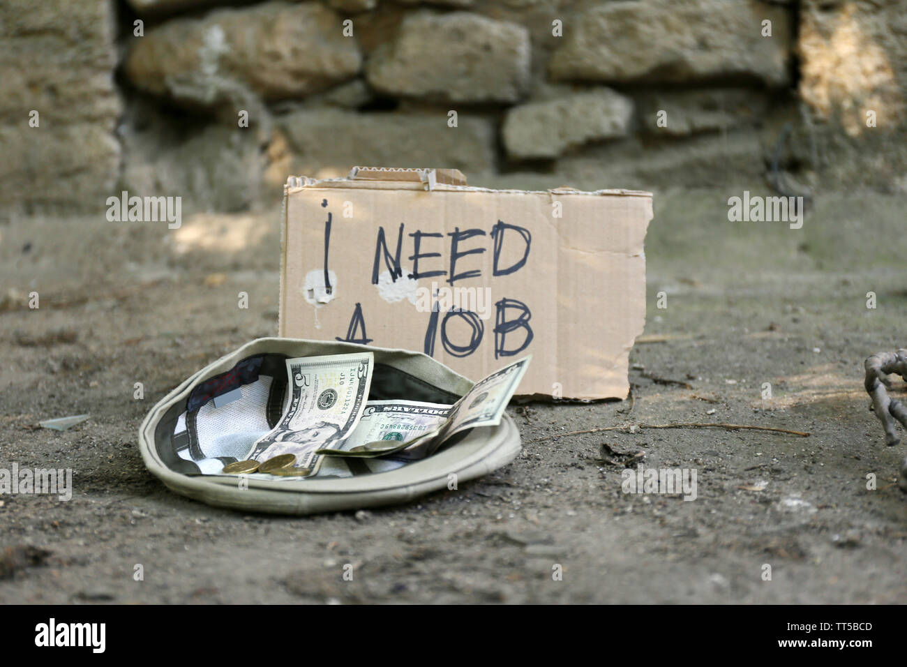 Hat homeless outdoors Stock Photo - Alamy