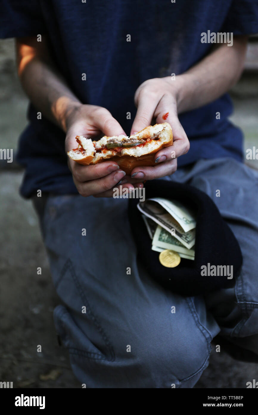 Homeless beggar food and money Stock Photo - Alamy