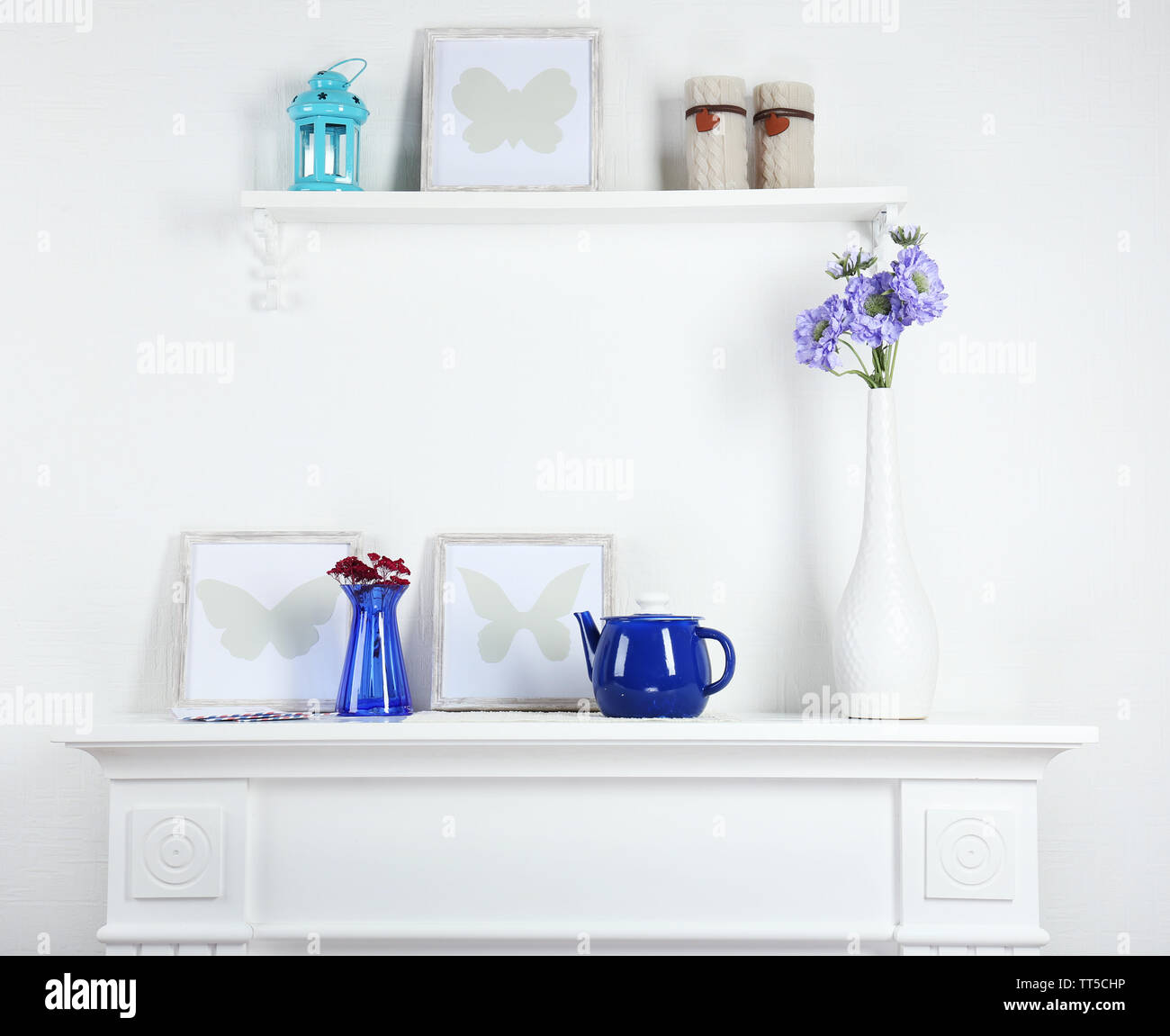Different objects on white shelf in living room Stock Photo - Alamy