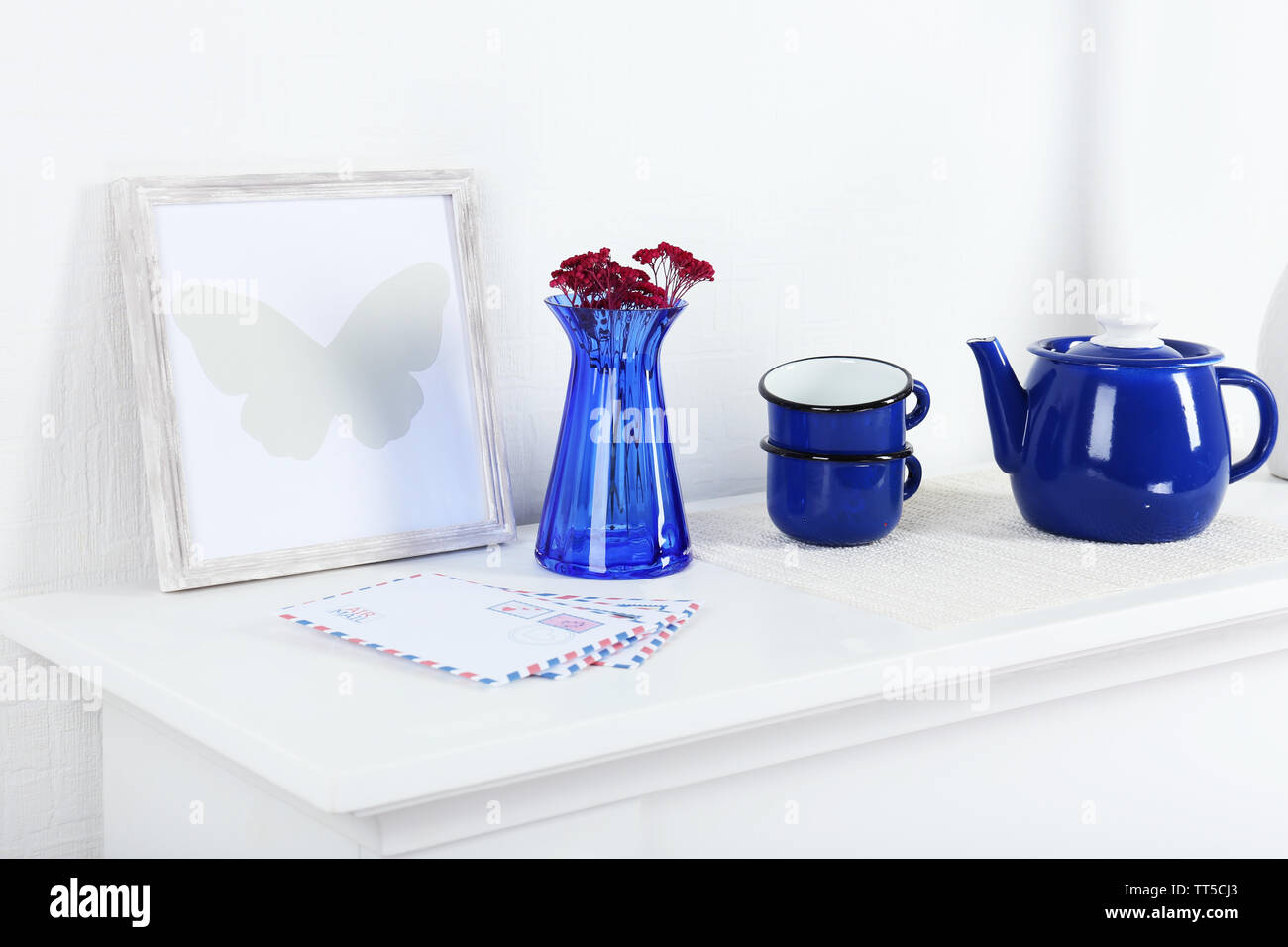 Different objects on white shelf in living room Stock Photo - Alamy