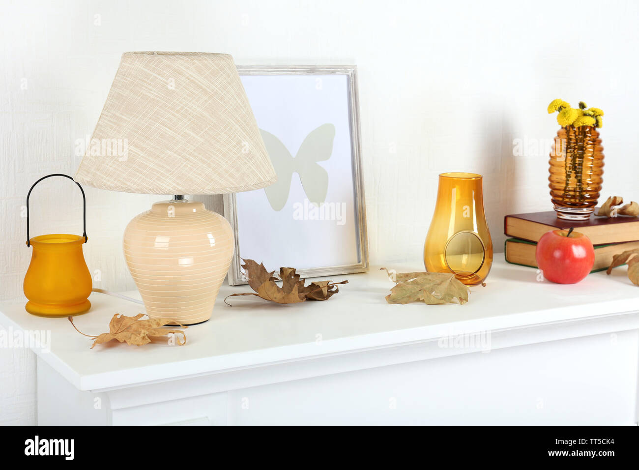 Different objects on white shelf in living room Stock Photo - Alamy