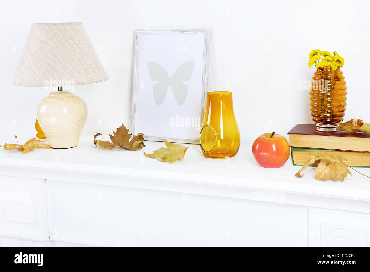 Different objects on white shelf in living room Stock Photo - Alamy