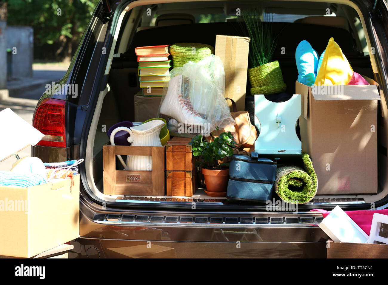 Moving boxes and suitcases in trunk of car, outdoors Stock Photo - Alamy
