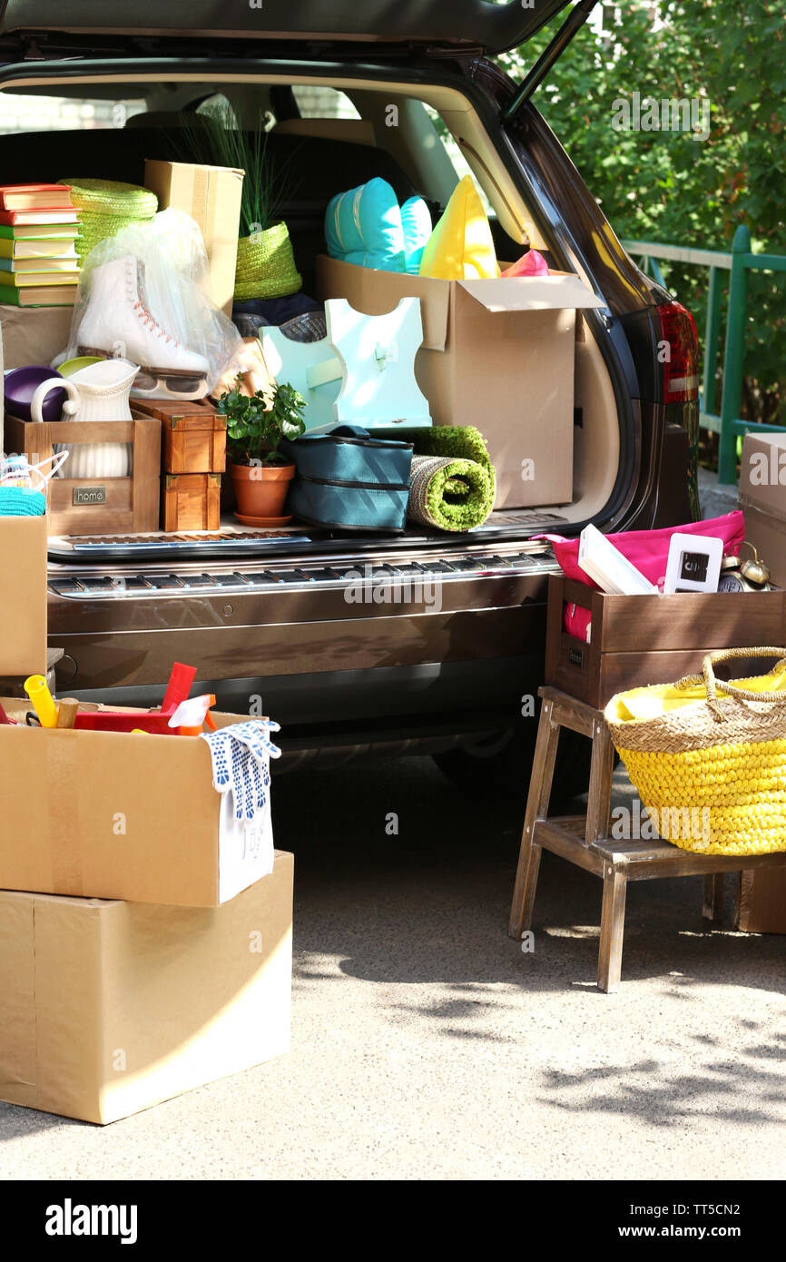 Moving boxes and suitcases in trunk of car, outdoors Stock Photo - Alamy