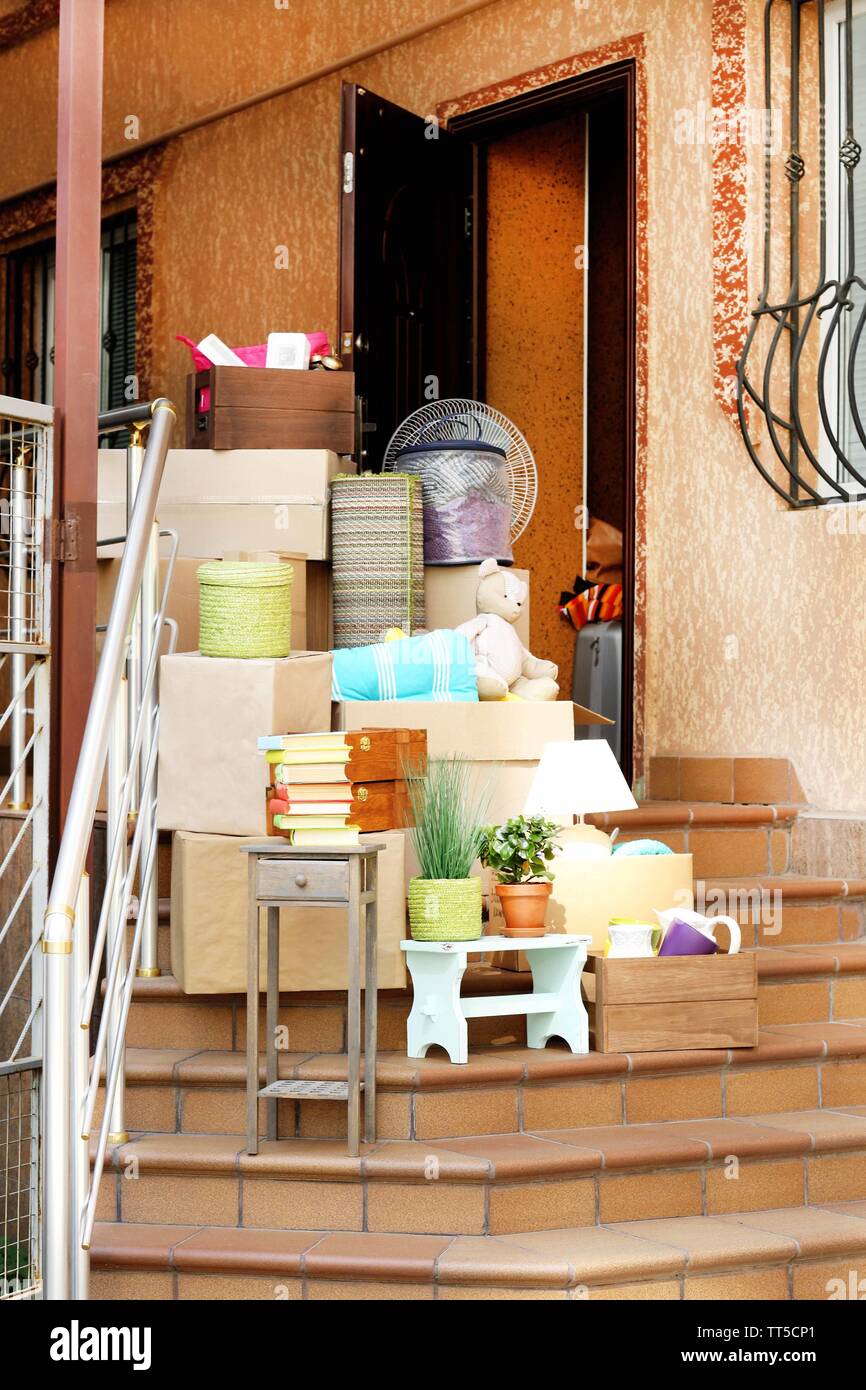 Moving boxes on stairs of new house, outdoors Stock Photo - Alamy