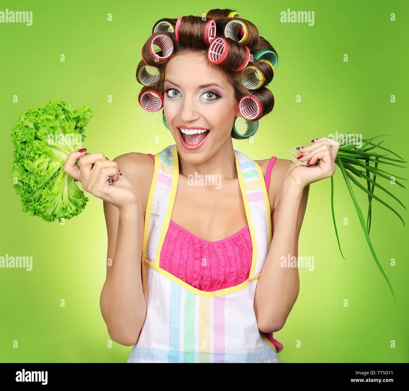 Beautiful girl in hair curlers on green background Stock Photo - Alamy