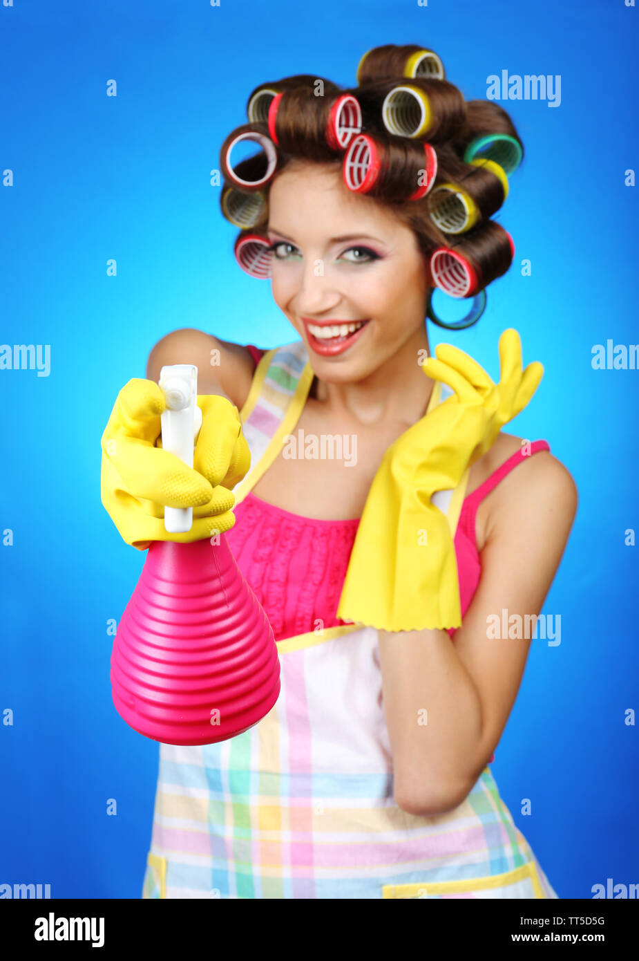 Beautiful girl in hair curlers on blue background Stock Photo - Alamy