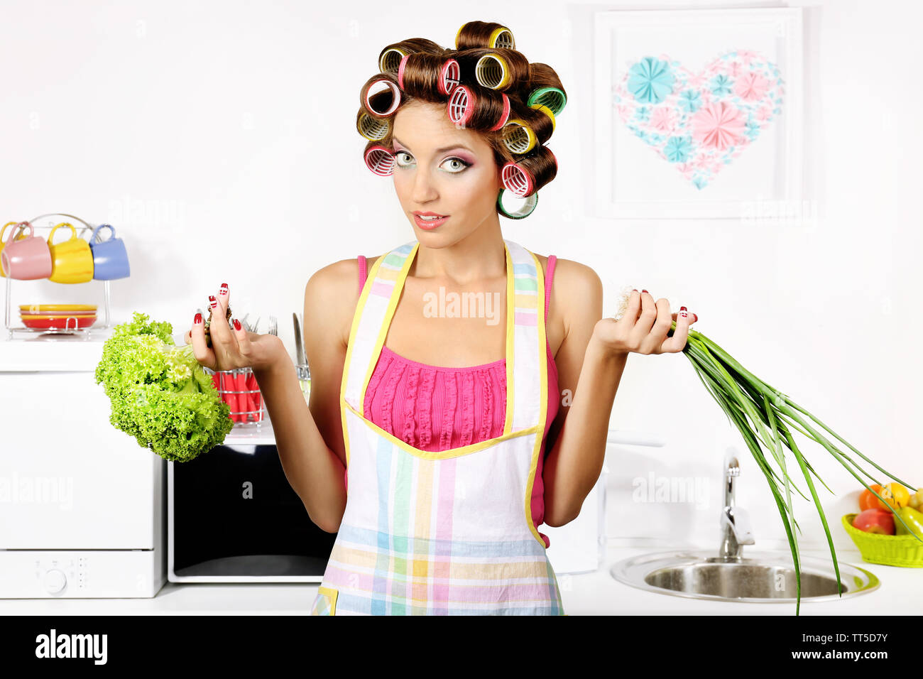 Beautiful girl in hair curlers in kitchen Stock Photo - Alamy