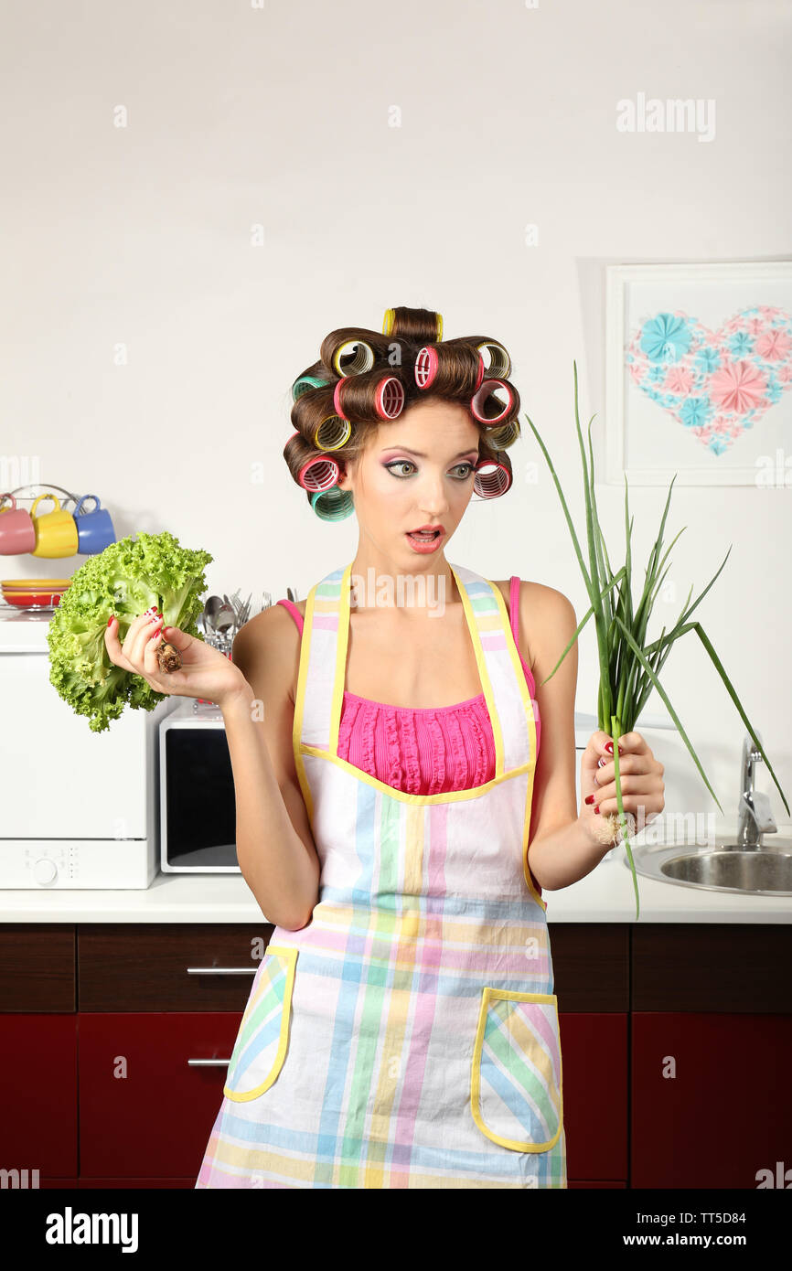 Beautiful girl in hair curlers in kitchen Stock Photo - Alamy