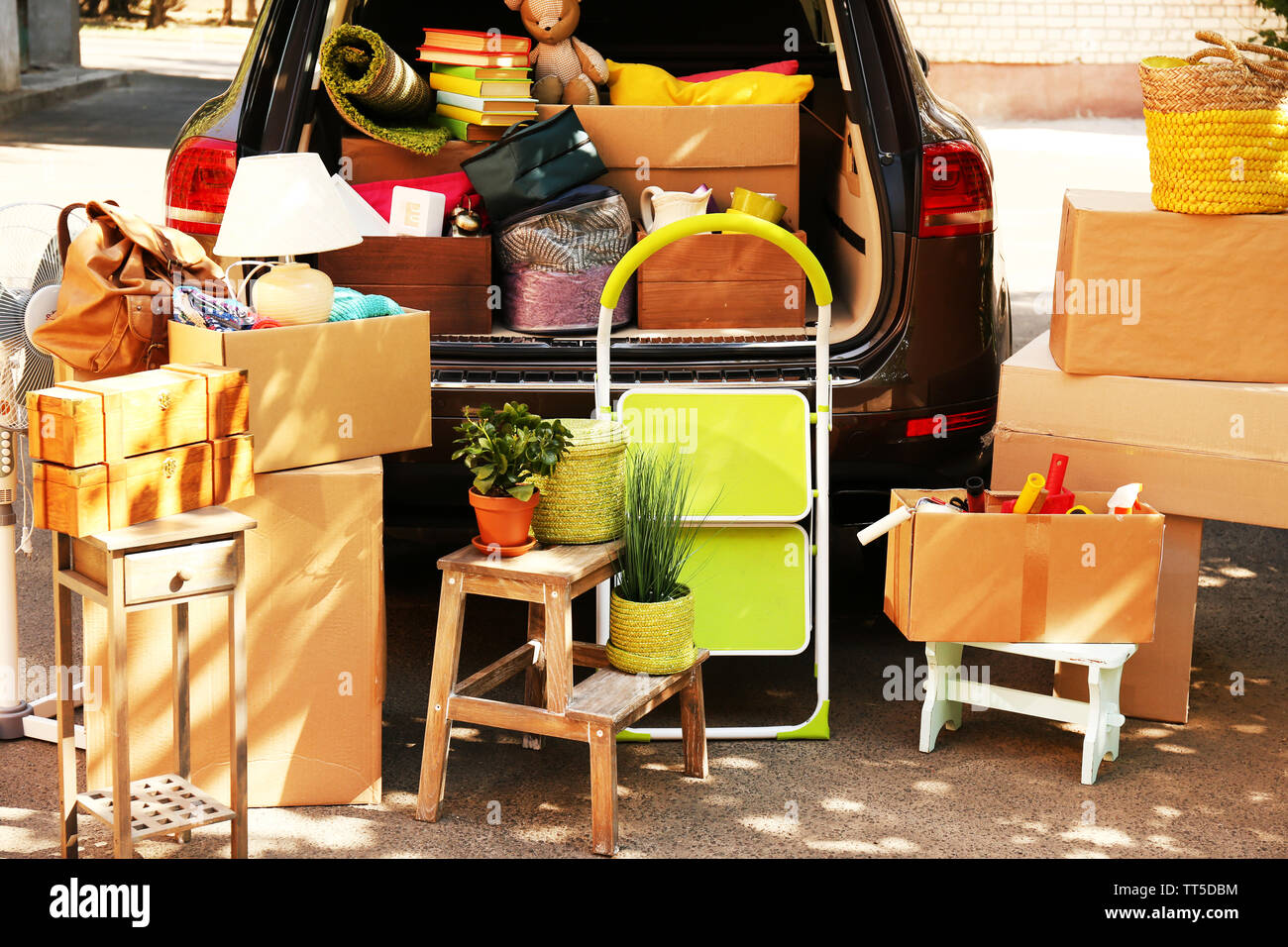 Moving boxes and suitcases in trunk of car, outdoors Stock Photo - Alamy