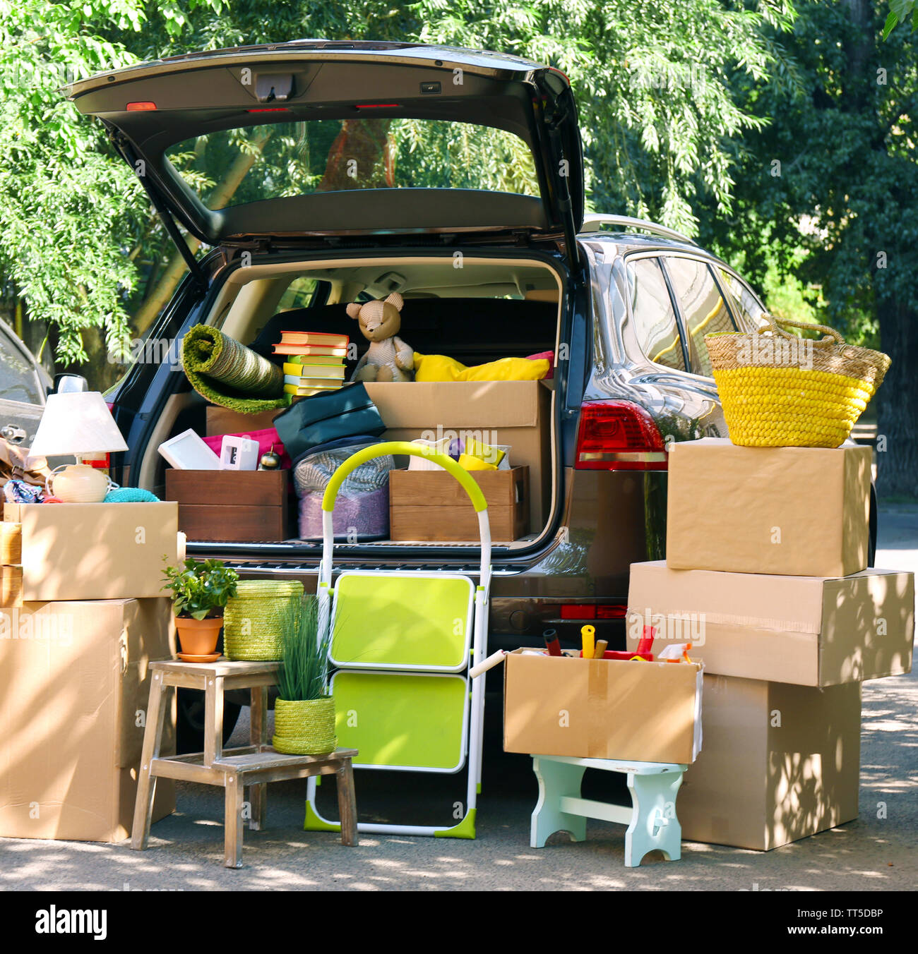 Moving boxes and suitcases in trunk of car, outdoors Stock Photo - Alamy