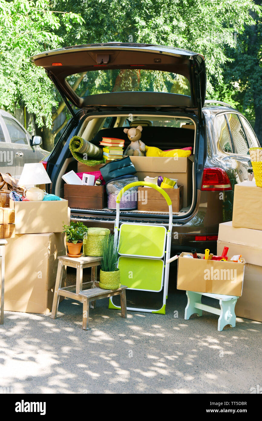 Moving boxes and suitcases in trunk of car, outdoors Stock Photo - Alamy