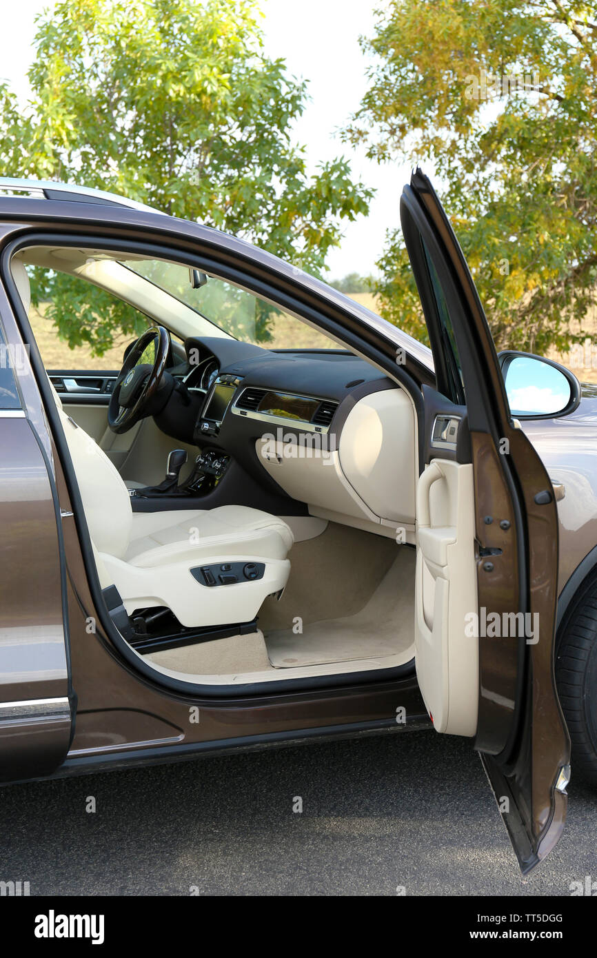 Modern car with open door, outdoors Stock Photo - Alamy
