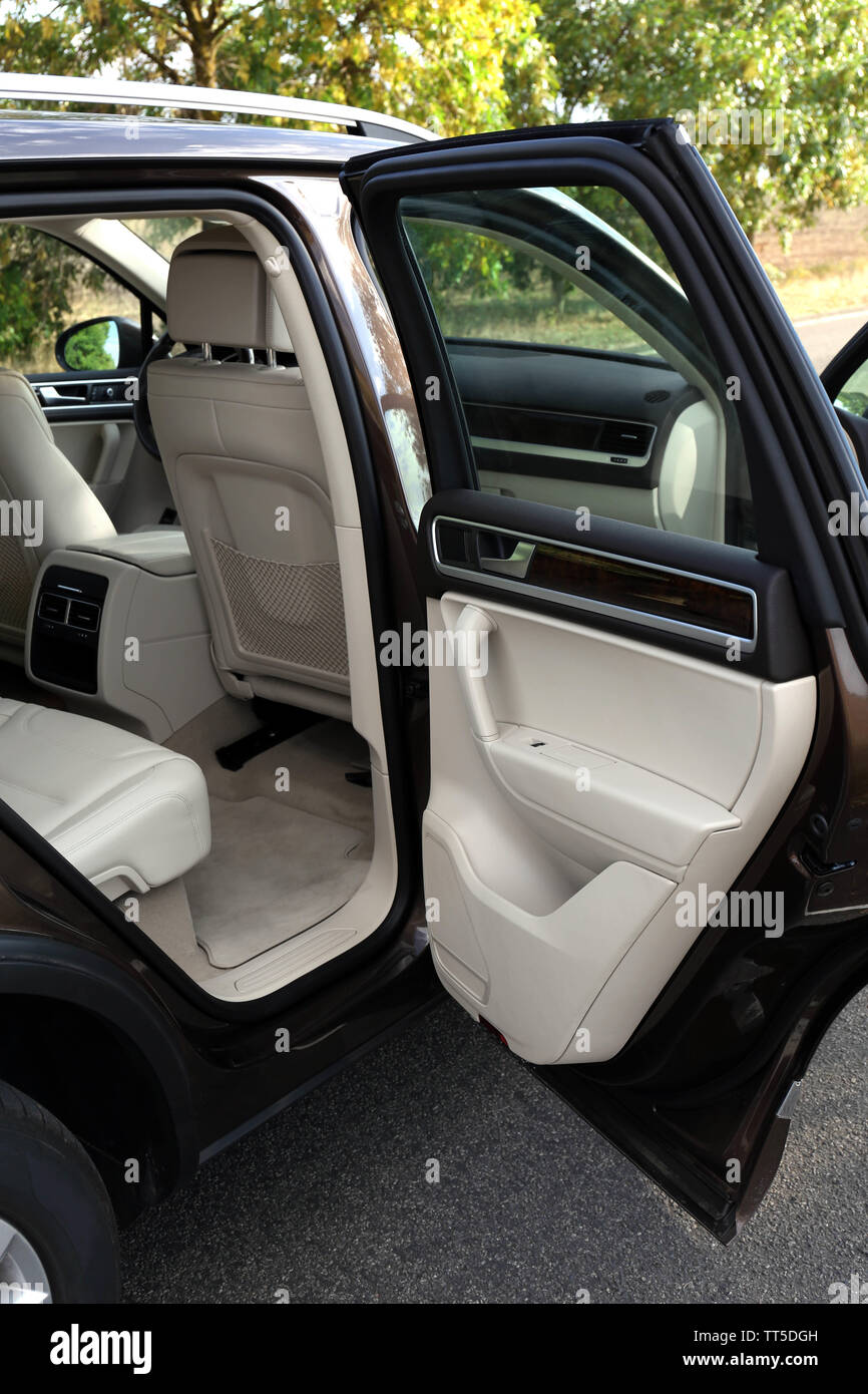 Modern car with open door, outdoors Stock Photo - Alamy
