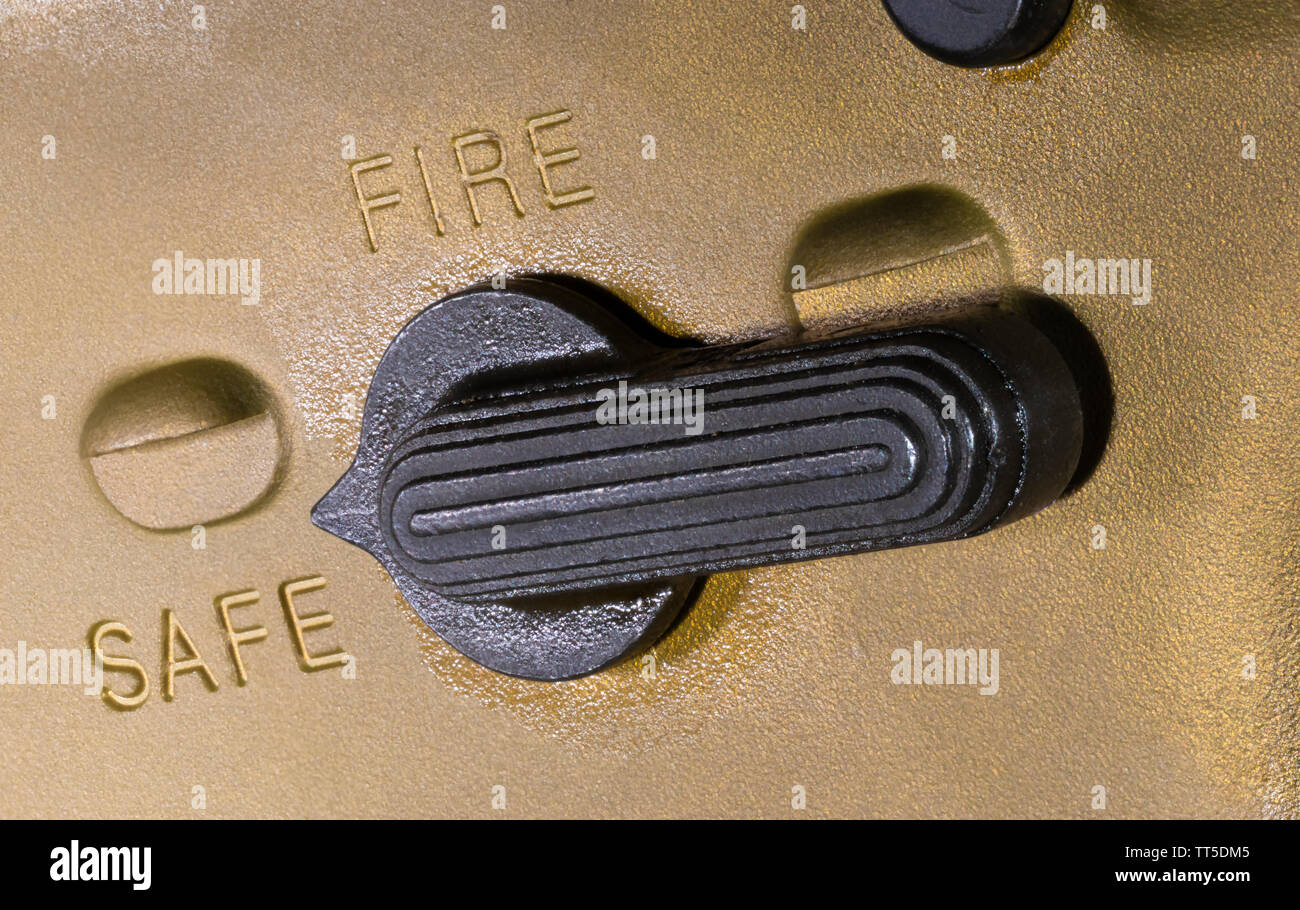 Assault rifle with a copper color that has its safety engaged Stock ...