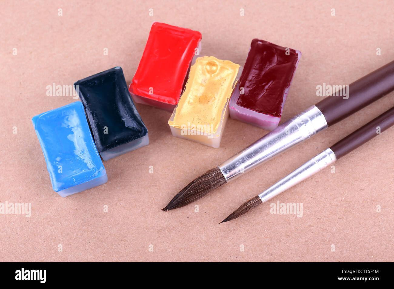 Watercolor paint cubes and brushes on beige background Stock Photo - Alamy