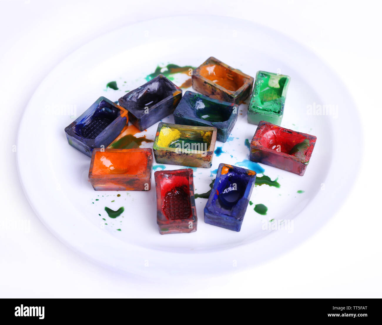 Watercolor paint cubes on plate isolated on white Stock Photo - Alamy