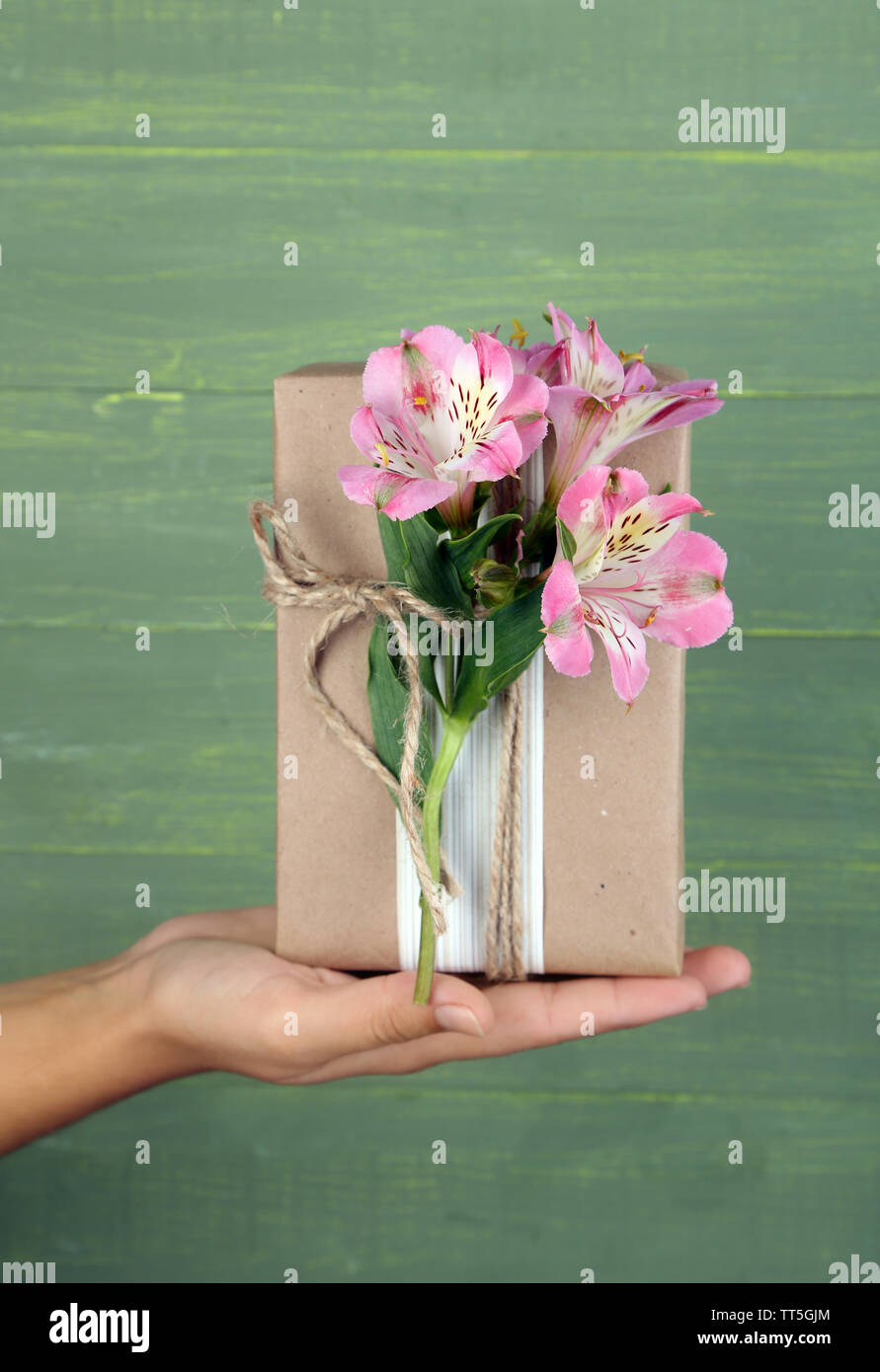 Female hand holding natural style handcrafted gift box with fresh ...