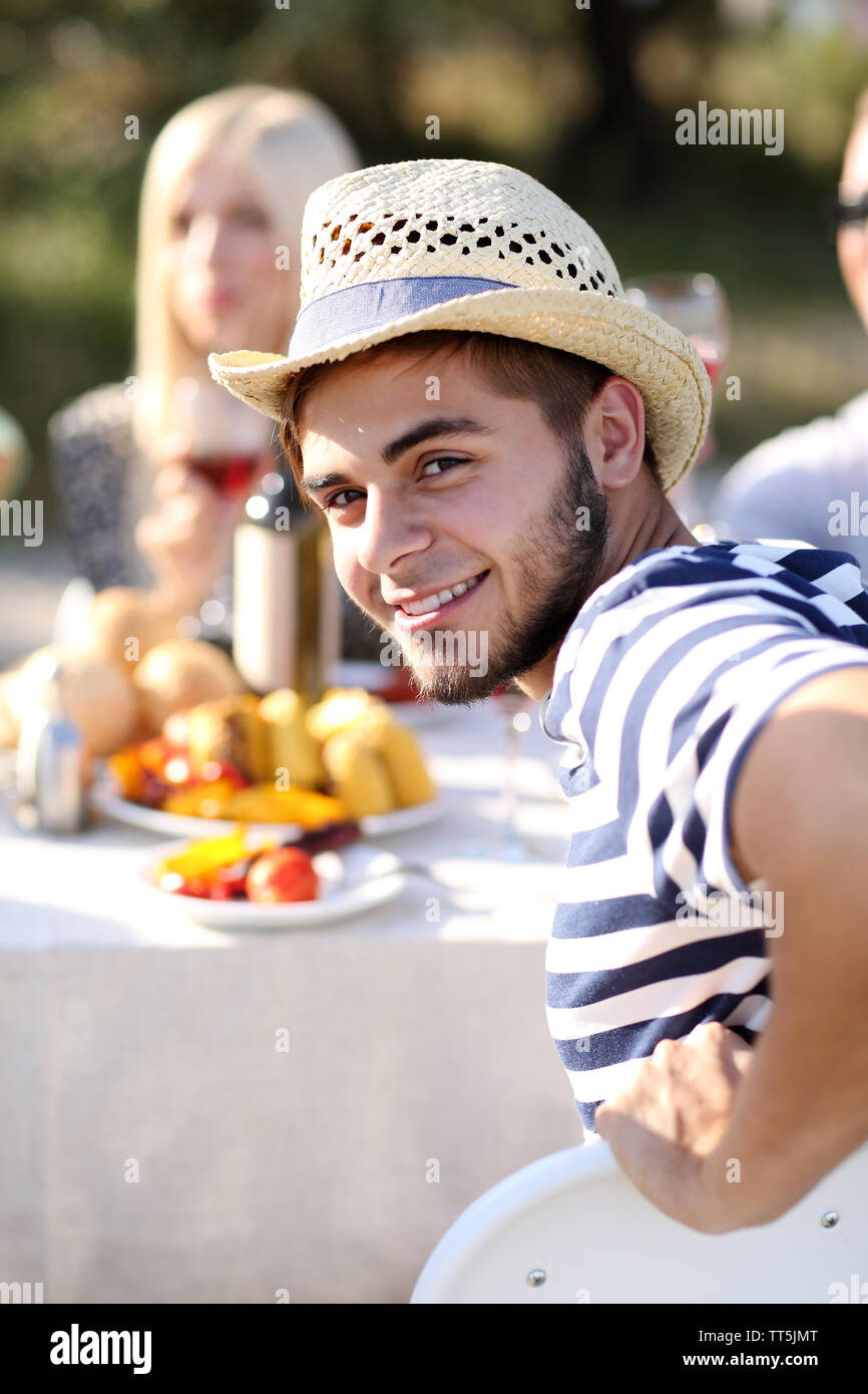 Young man with friends on rest, outdoors Stock Photo - Alamy