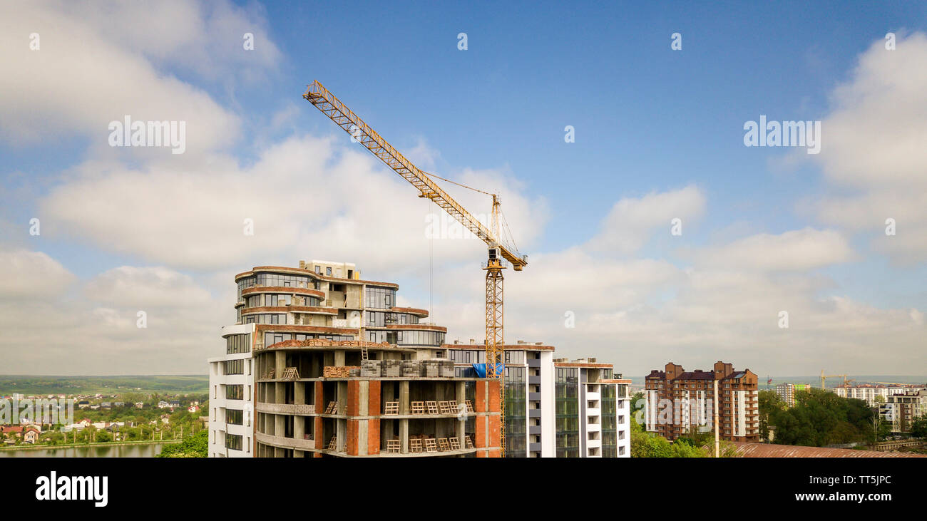 Apartment or office tall building under construction. Brick walls ...