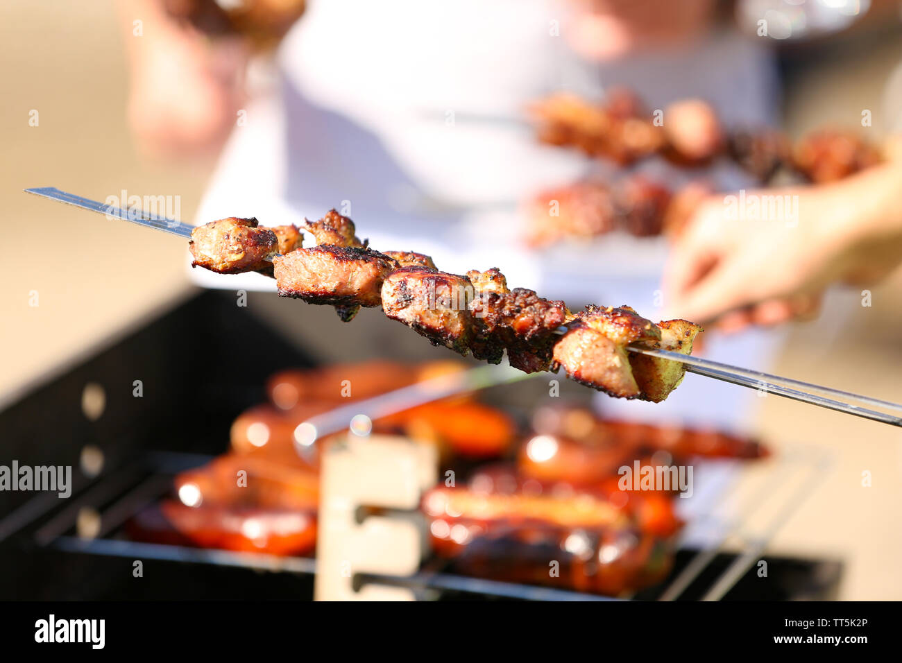 Young friends having barbecue party. Hands with skewers, close-up Stock ...