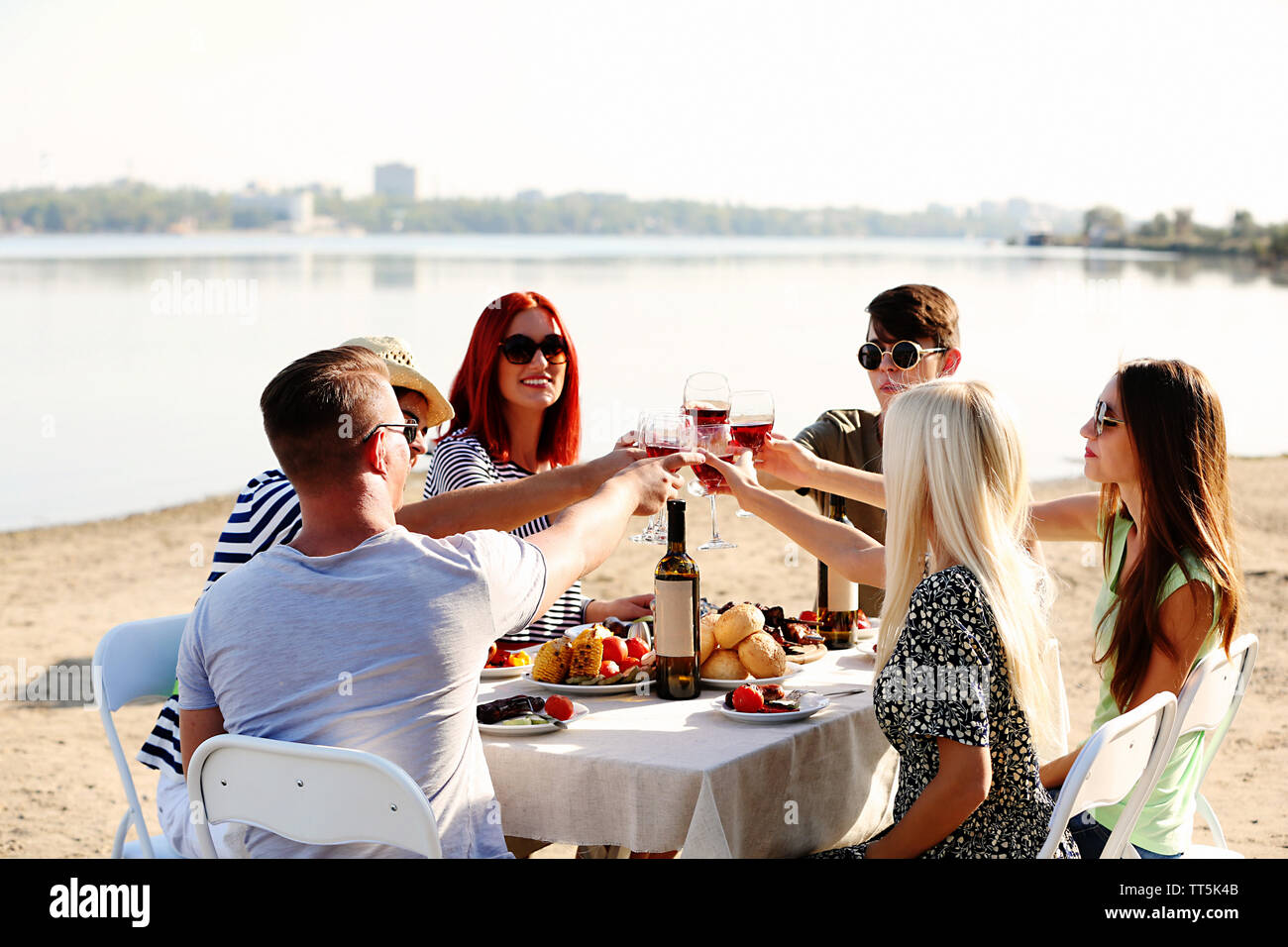 Happy friends on rest at beach Stock Photo - Alamy