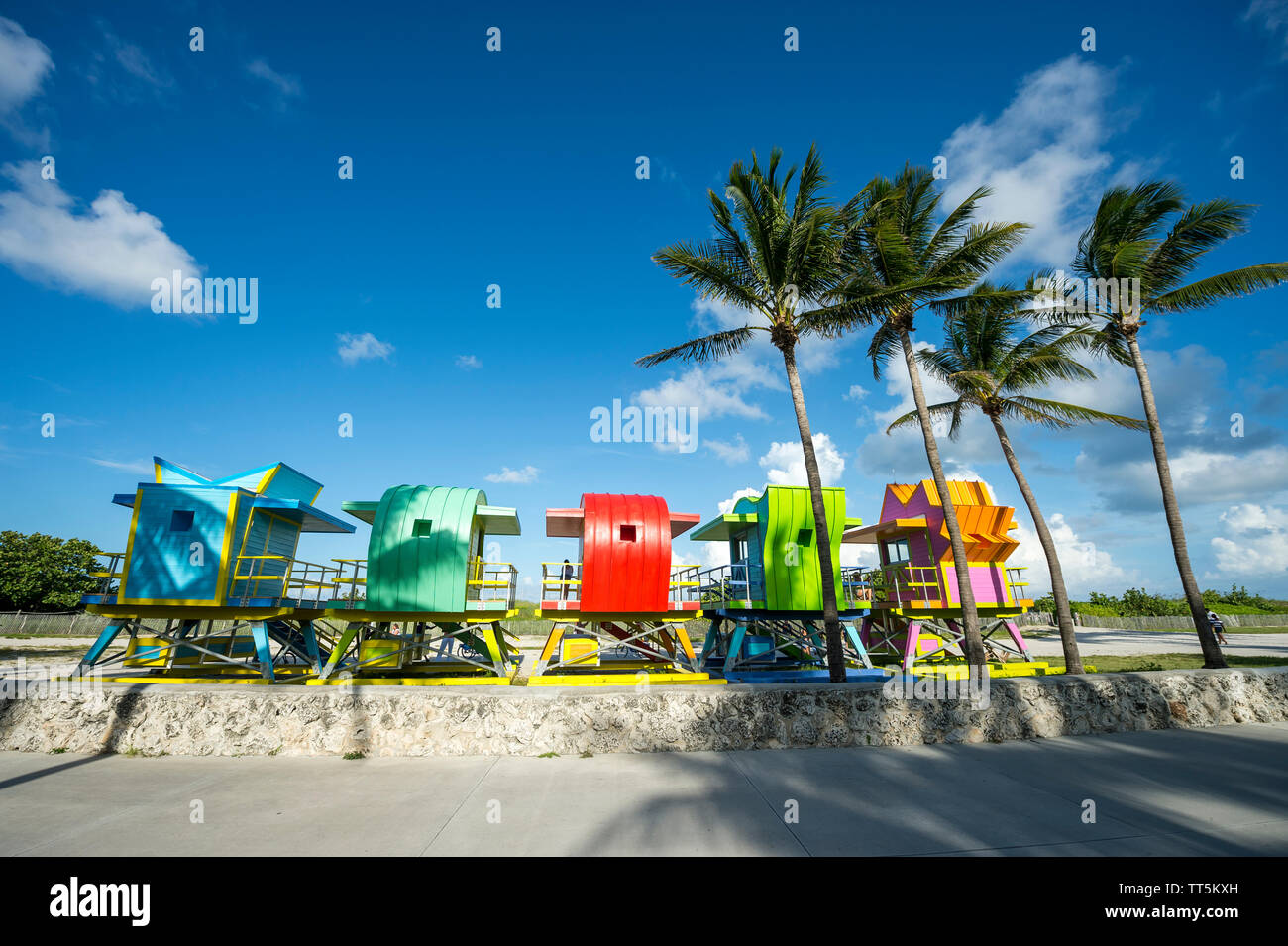 Colorful scenic morning view of brightly painted lifeguard towers with ...