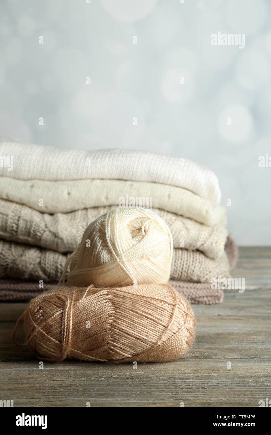 Knitting clothes and yarn on light background Stock Photo - Alamy