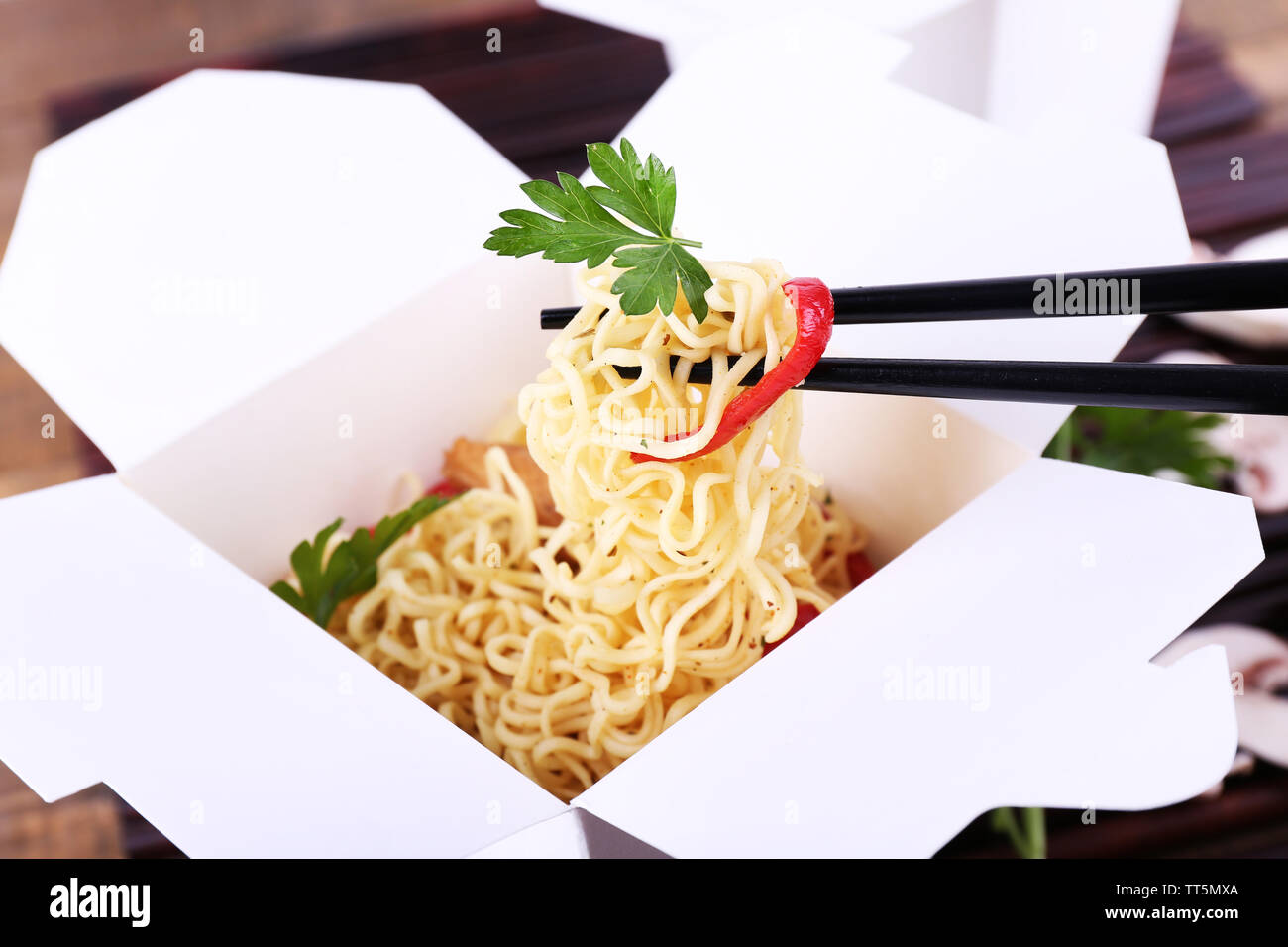 Chinese noodles in takeaway boxes on bamboo mat background Stock Photo ...