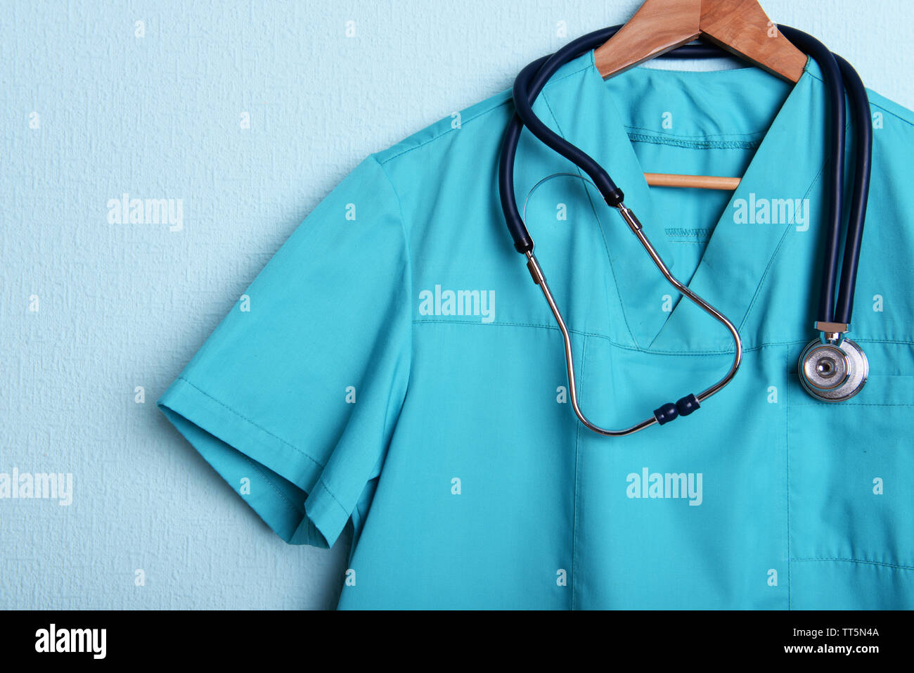 Doctor shirt with stethoscope on hanger on blue background Stock Photo ...
