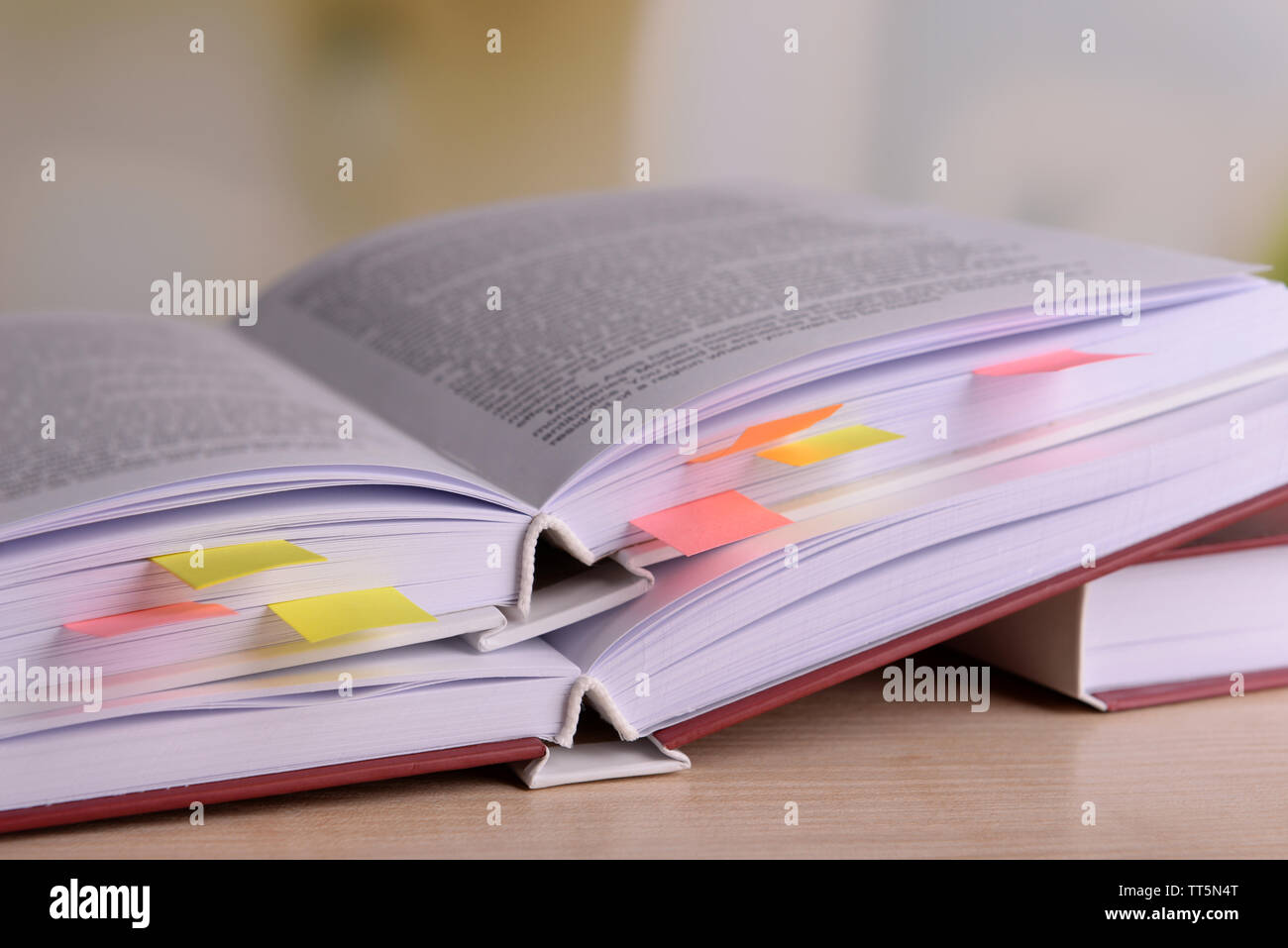 Books with bookmarks on table on bright background Stock Photo - Alamy