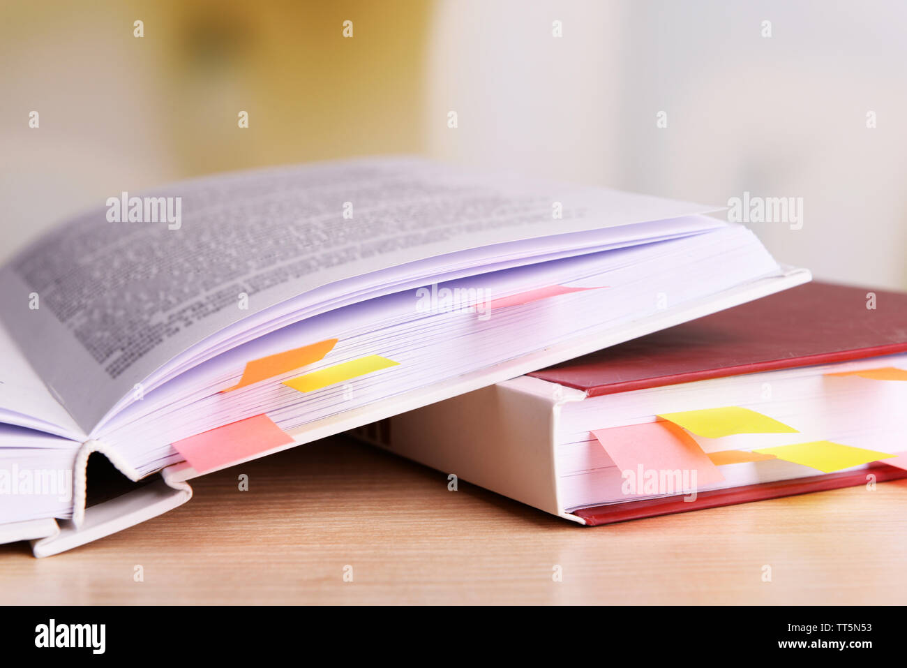 Books with bookmarks on table on bright background Stock Photo - Alamy
