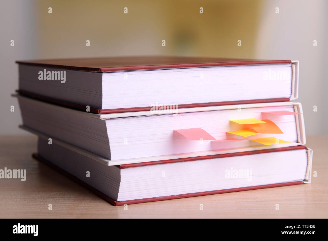 Books with bookmarks on table on bright background Stock Photo - Alamy