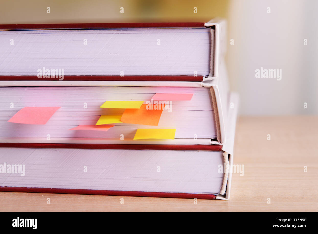 Books with bookmarks on table on bright background Stock Photo - Alamy