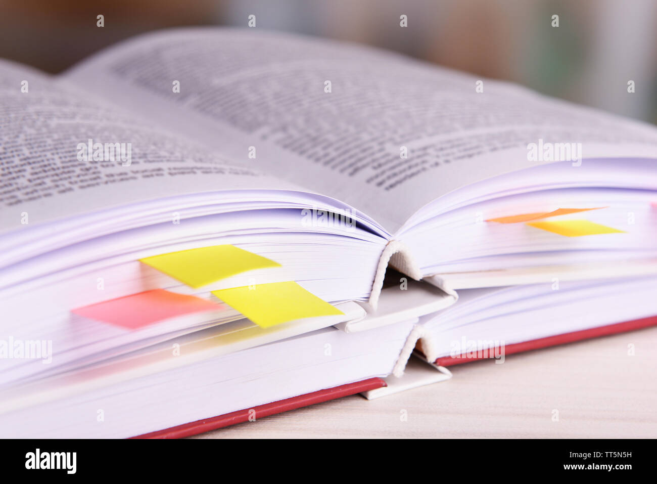 Books with bookmarks on table on bright background Stock Photo - Alamy