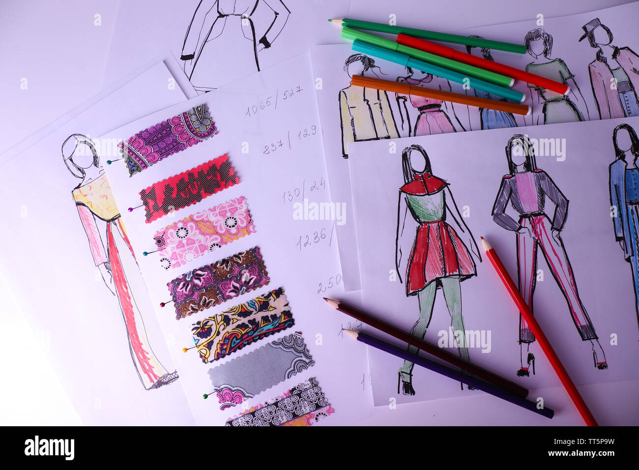 Sketches of clothes and fabric samples on table Stock Photo - Alamy