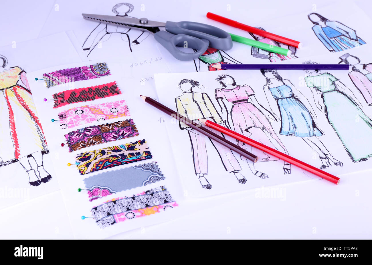 Sketches of clothes and fabric samples on table Stock Photo - Alamy
