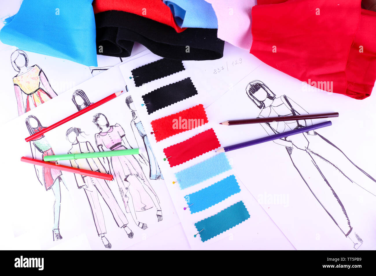 Sketches of clothes and fabric samples on table Stock Photo - Alamy