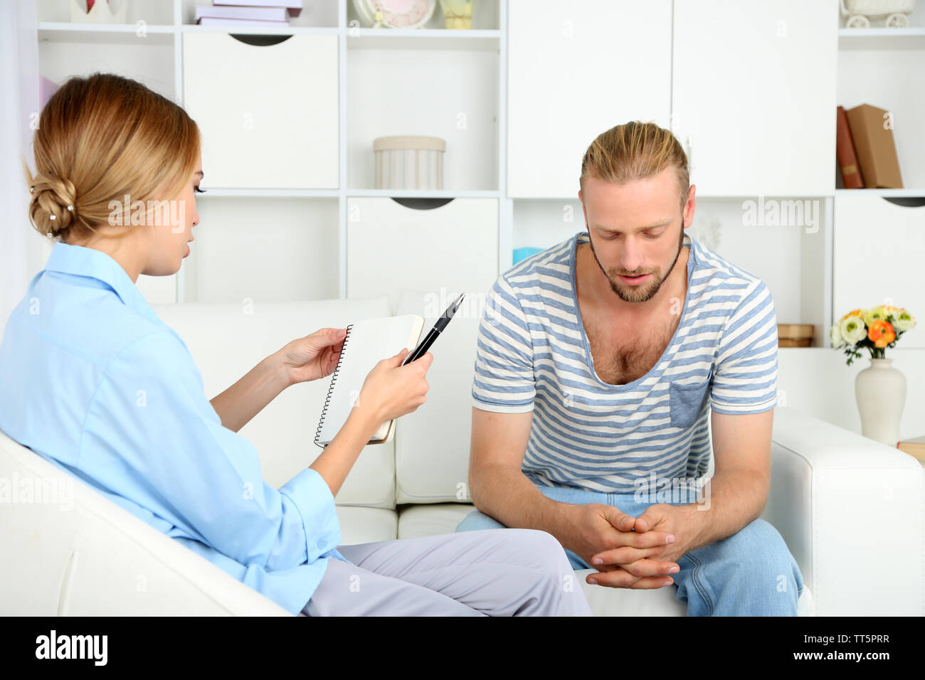 Young man on reception at psychologist Stock Photo - Alamy