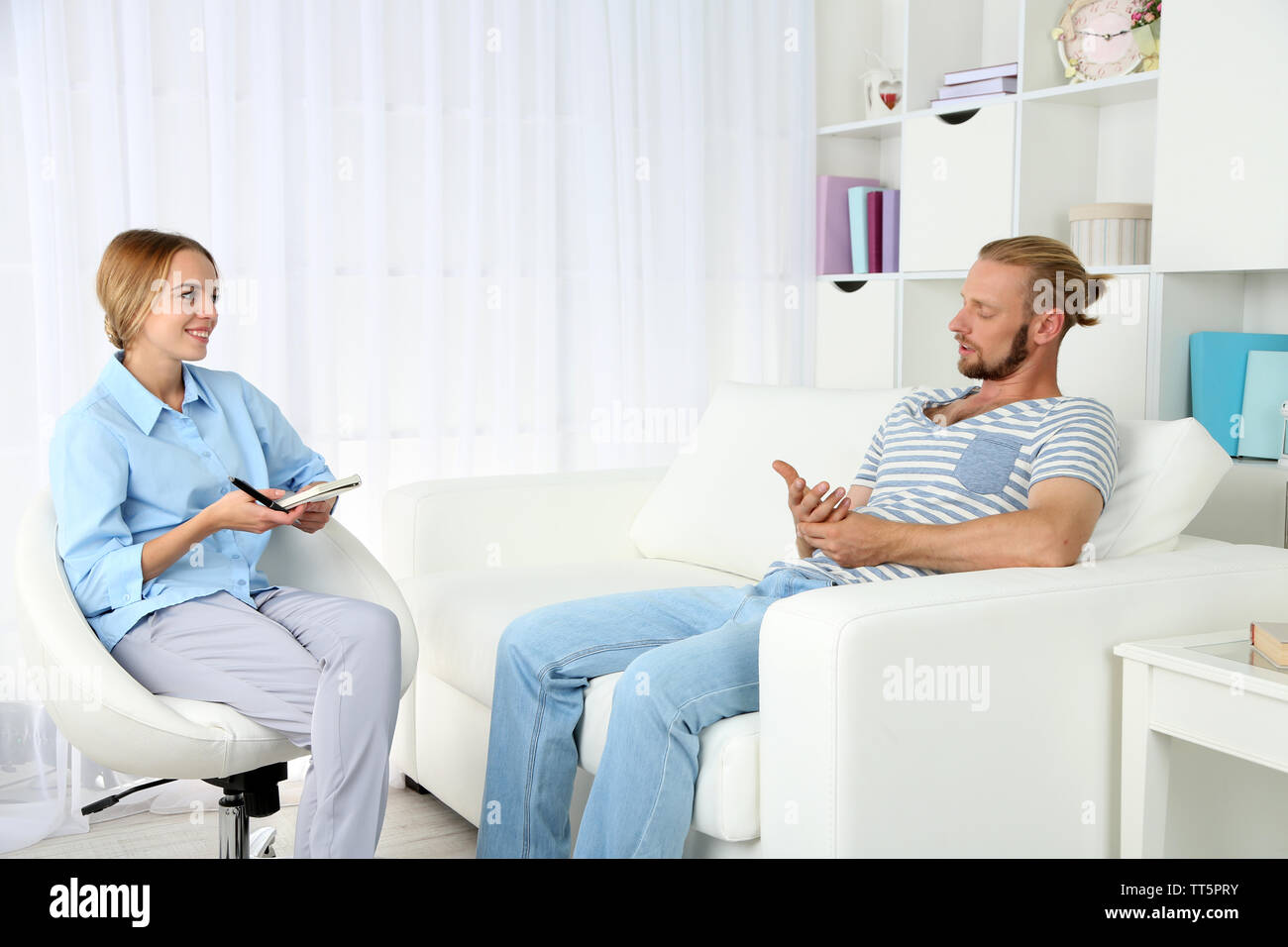Young man on reception at psychologist Stock Photo - Alamy