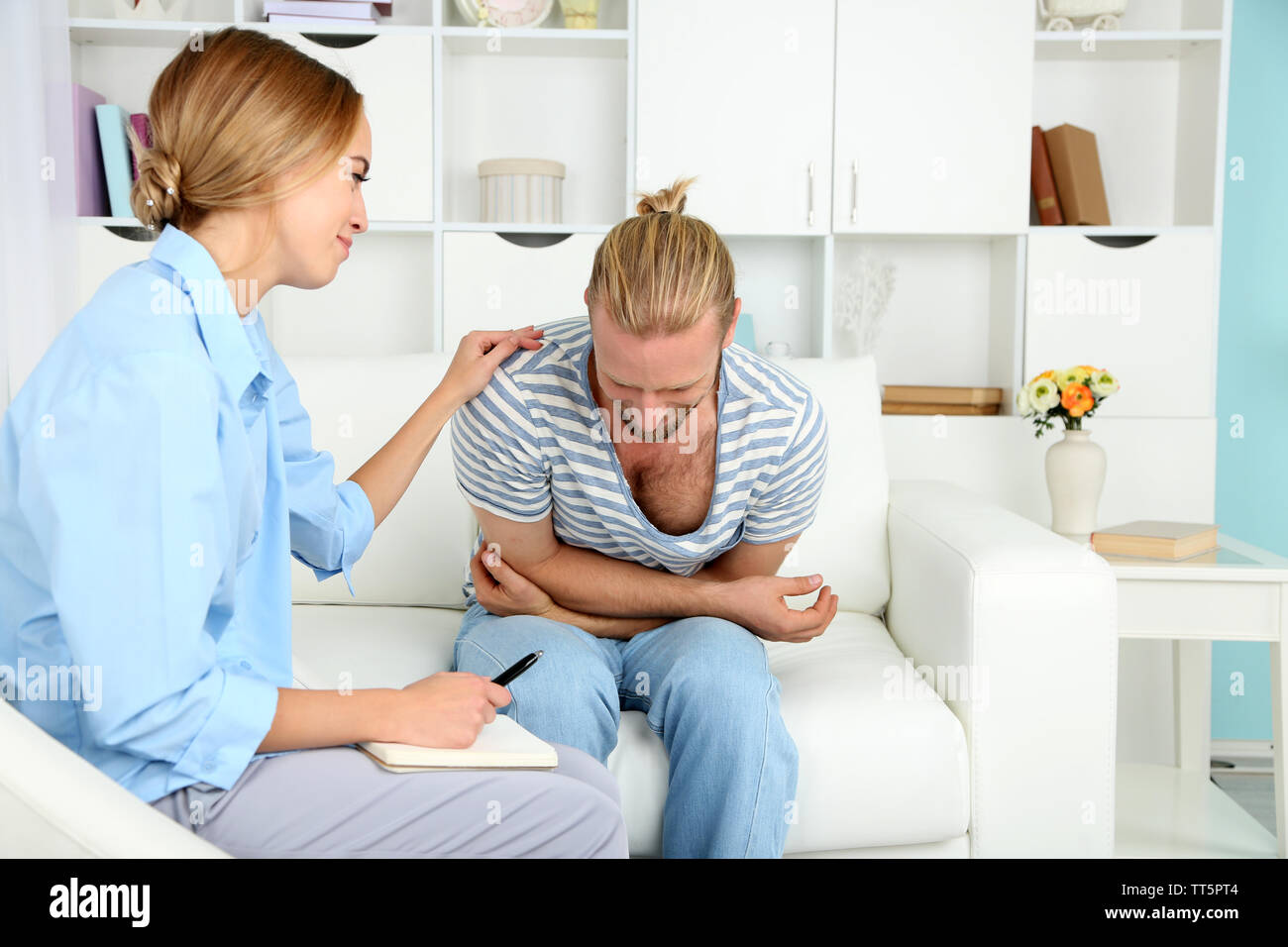 Young man on reception at psychologist Stock Photo - Alamy