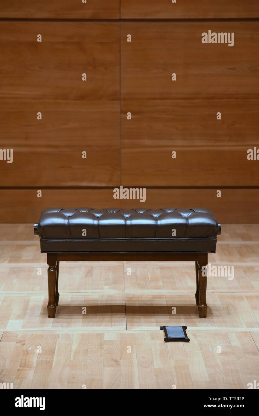 Brown wooden piano stool on the wooden stage in concert hall Stock ...