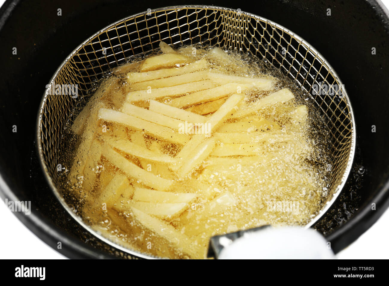 French fries in deep fryer, closeup Stock Photo - Alamy