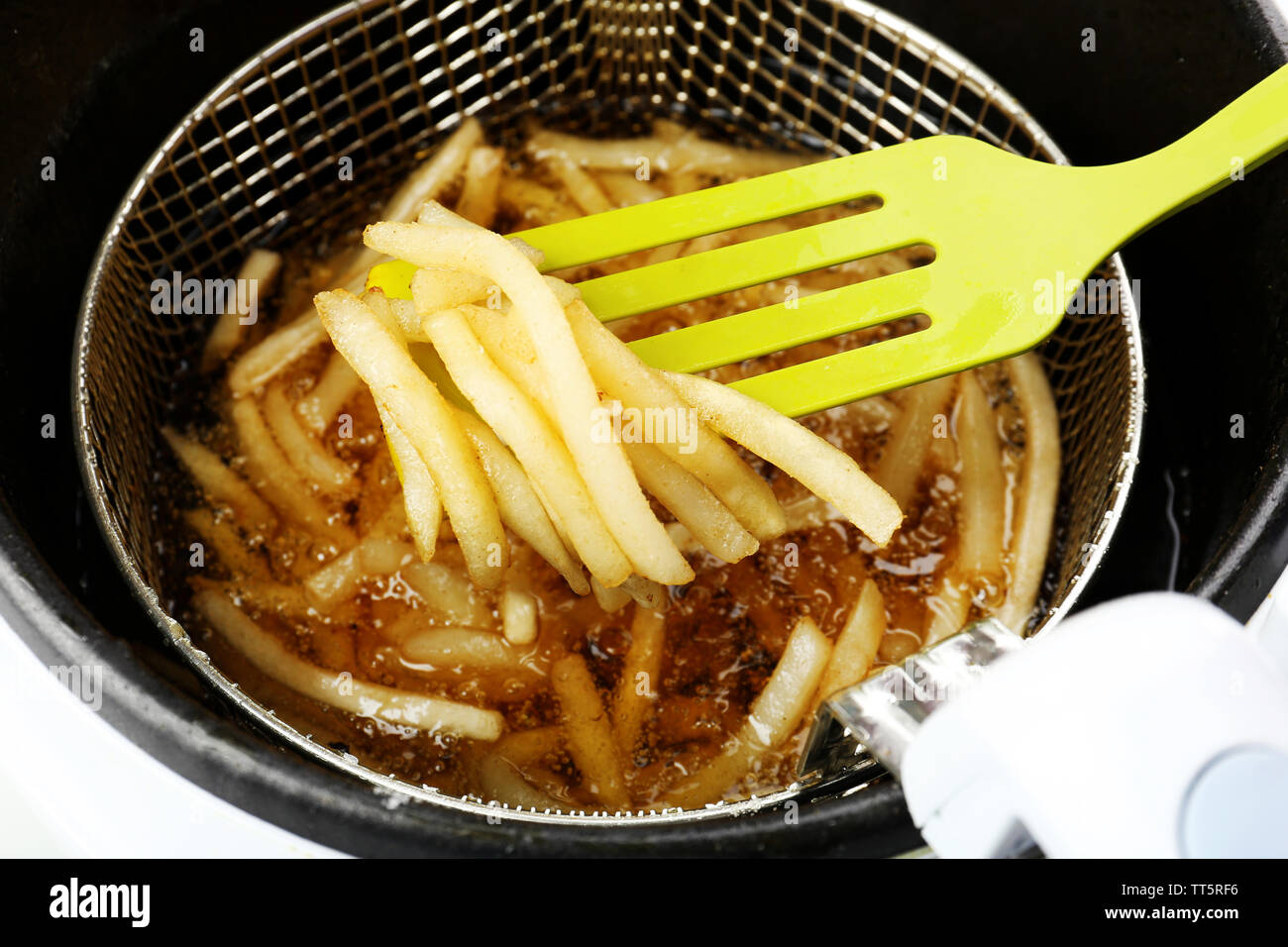French fries in deep fryer, closeup Stock Photo - Alamy