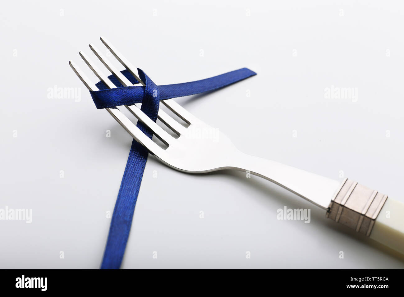 Stages of tying bow on fork close-up Stock Photo - Alamy